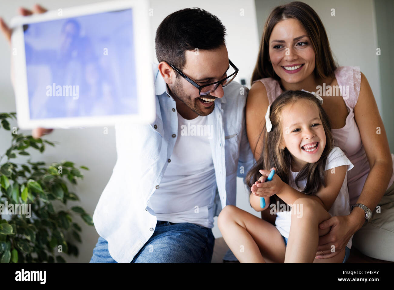 Happy family having fun time at home Stock Photo - Alamy