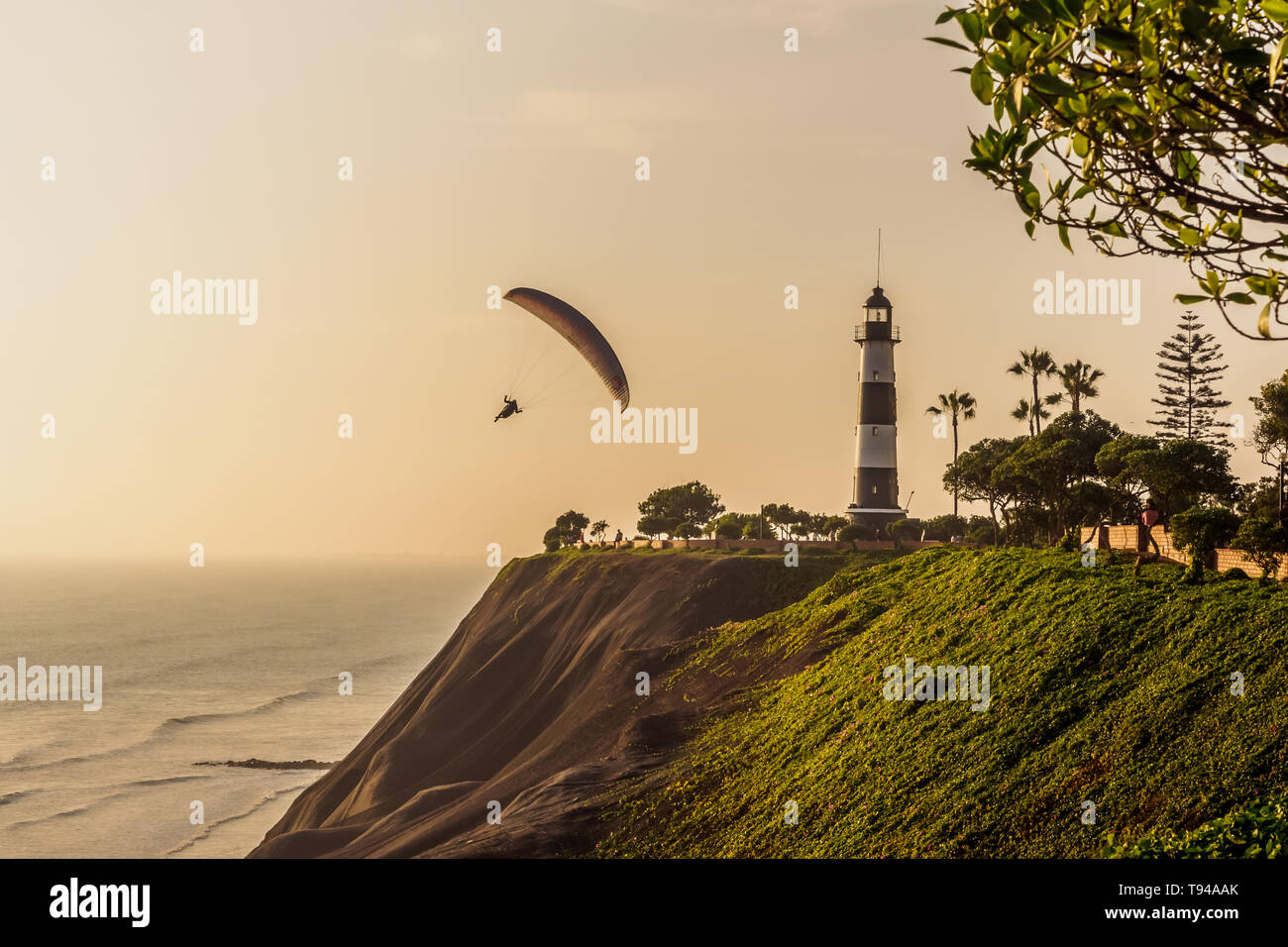 Paragliding on the cliffs of the city of Lima in Peru during sunset ...