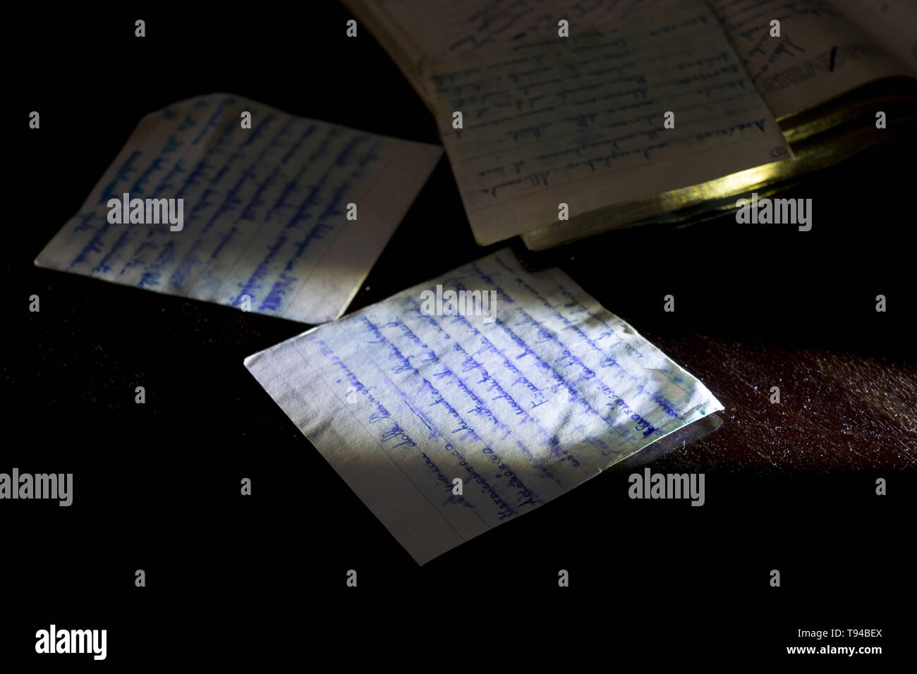 old handwritten letter illumined from lateral light Stock Photo - Alamy