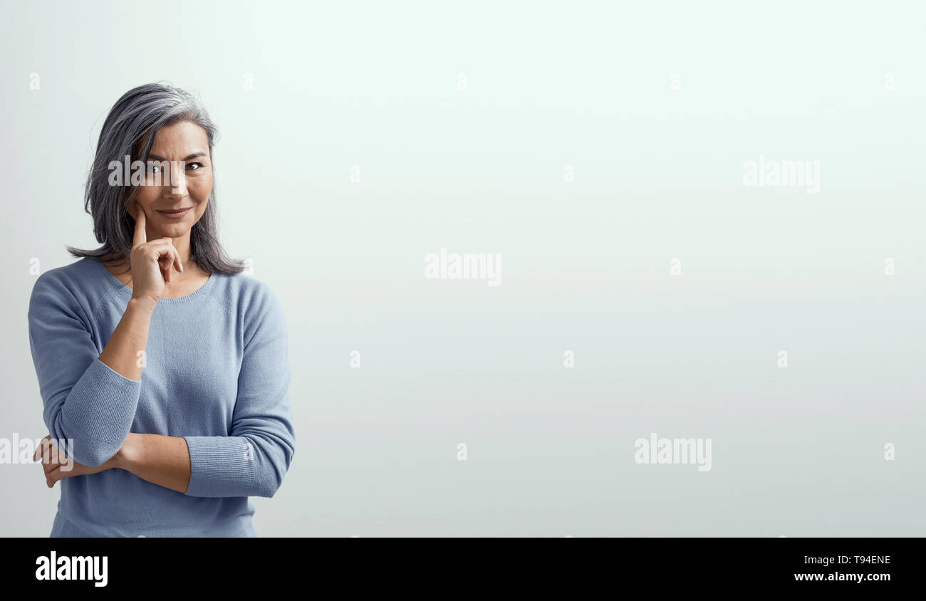 Beautiful woman pointing cheek hi-res stock photography and images - Alamy