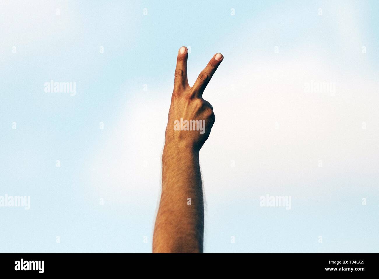 A Muslim man's hand showing a peece sign Stock Photo - Alamy