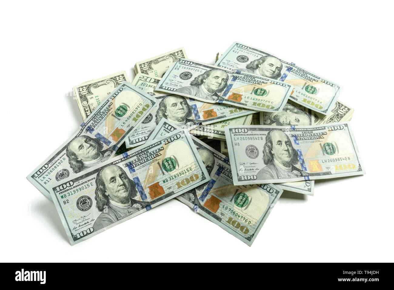 pile of twenty and one hundred dollar bills isolated on a white ...