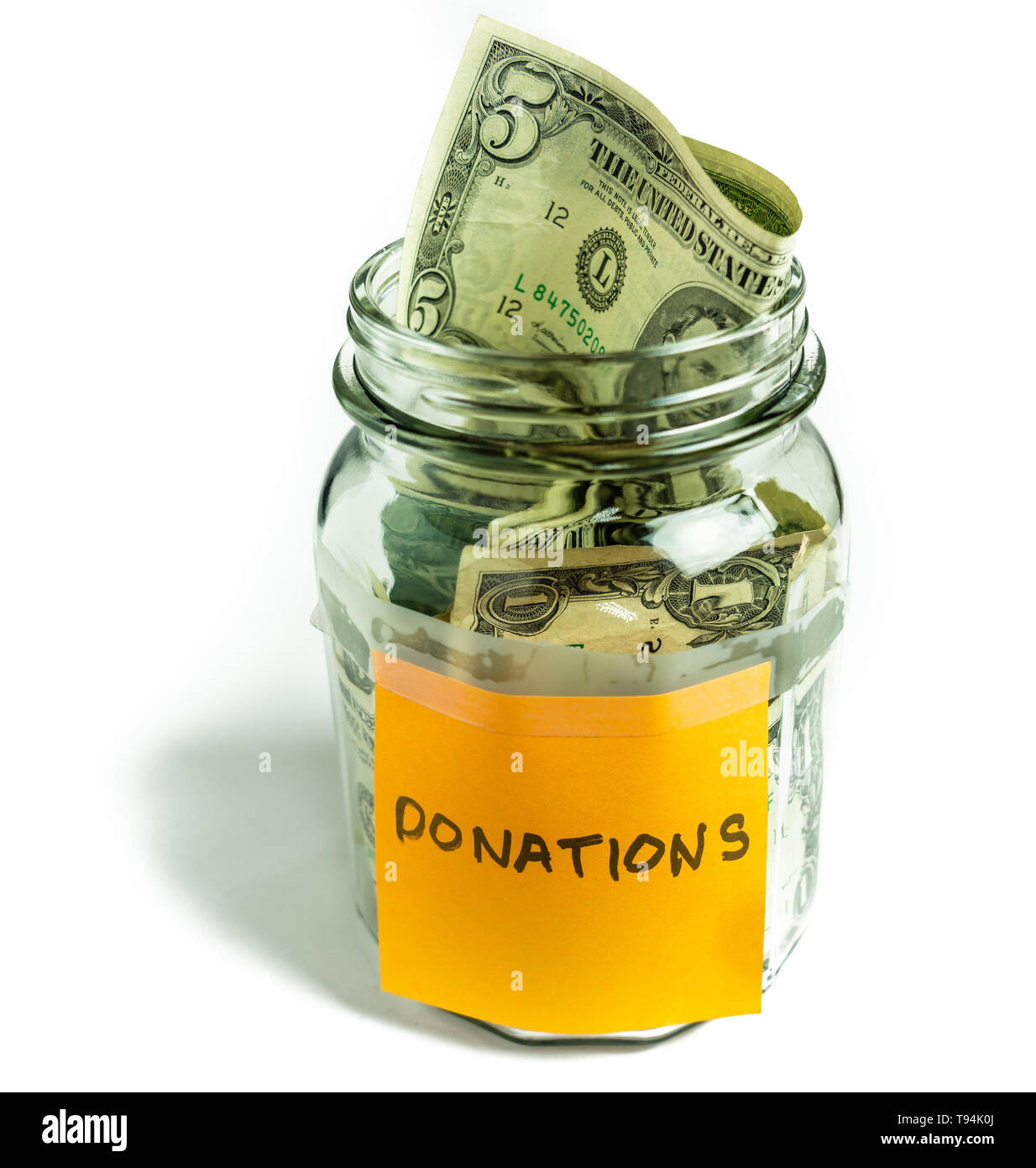 donation jar filled with one and five dollar bills in US currency ...
