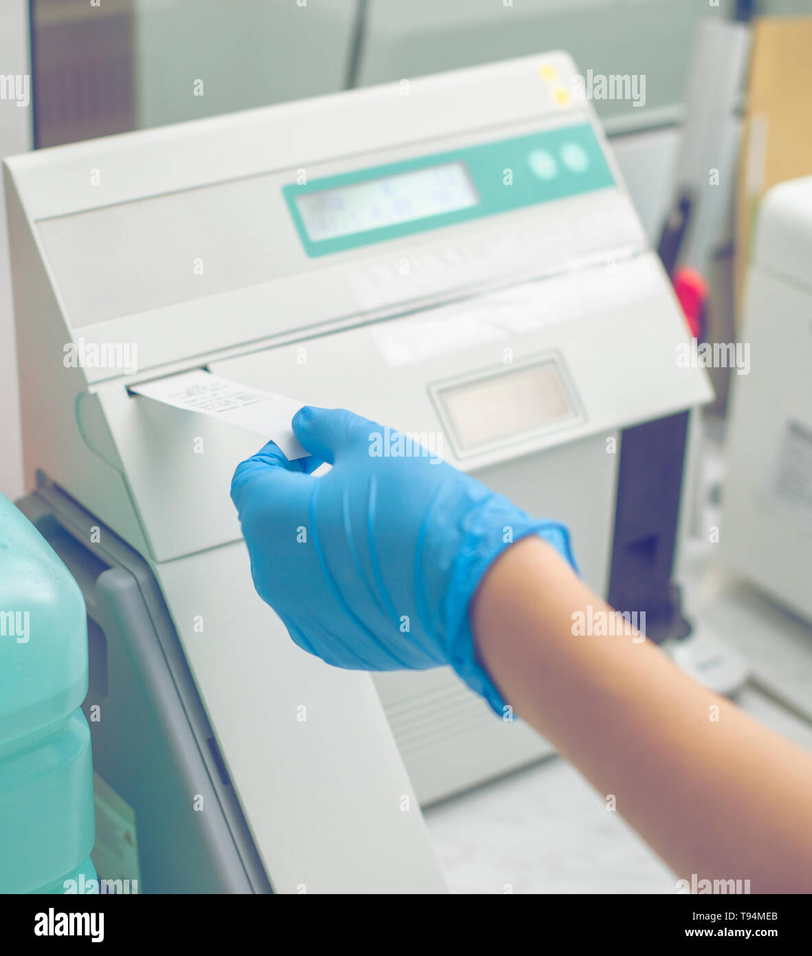 Woman working in a laboratory on a modern machine for blood testing ...