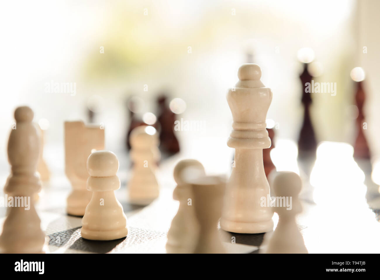 Game board with chess pieces on blurred background Stock Photo - Alamy