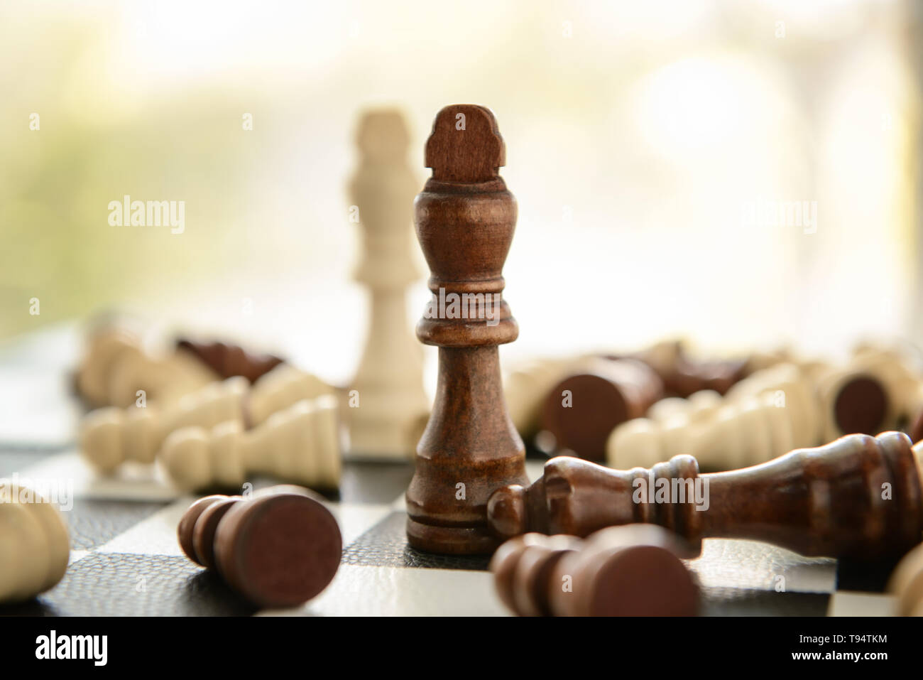 Game board with chess pieces on blurred background Stock Photo - Alamy