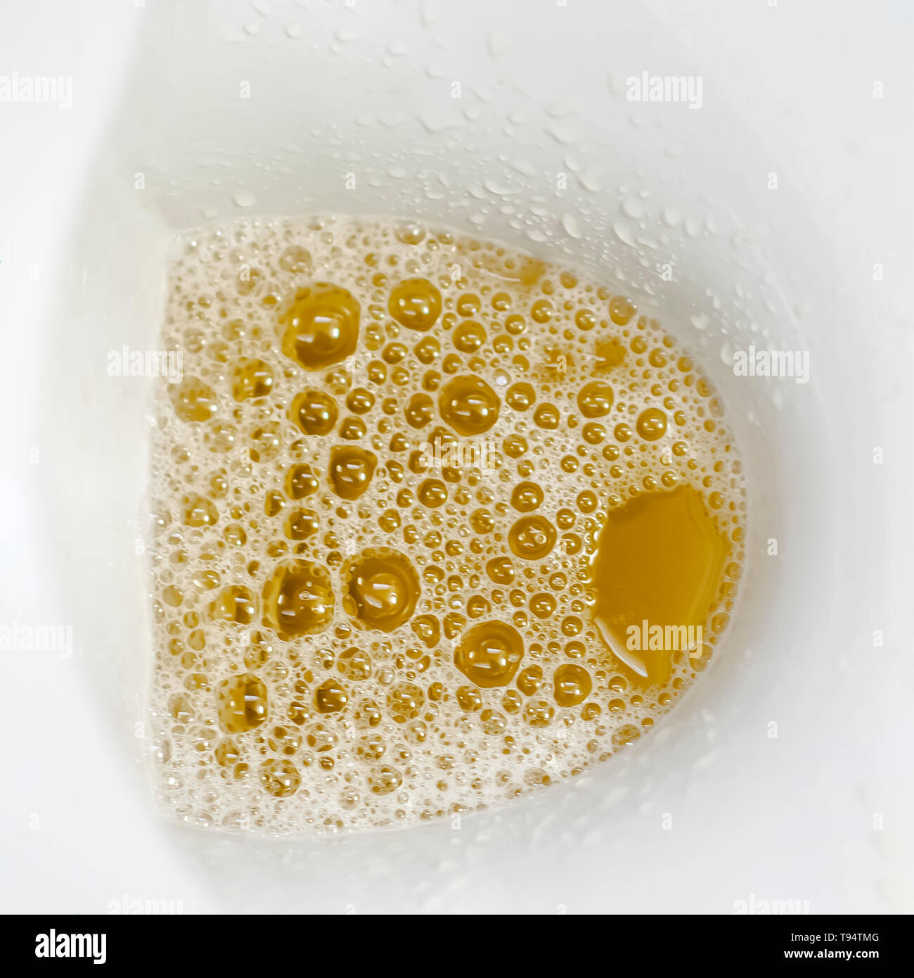 Bubbles on an golden yellow Liquid Stock Photo - Alamy