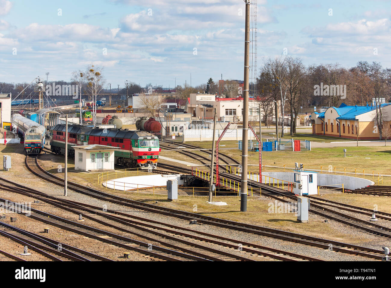 Diesel locomotive and train at entrance fork of railway turntable in ...