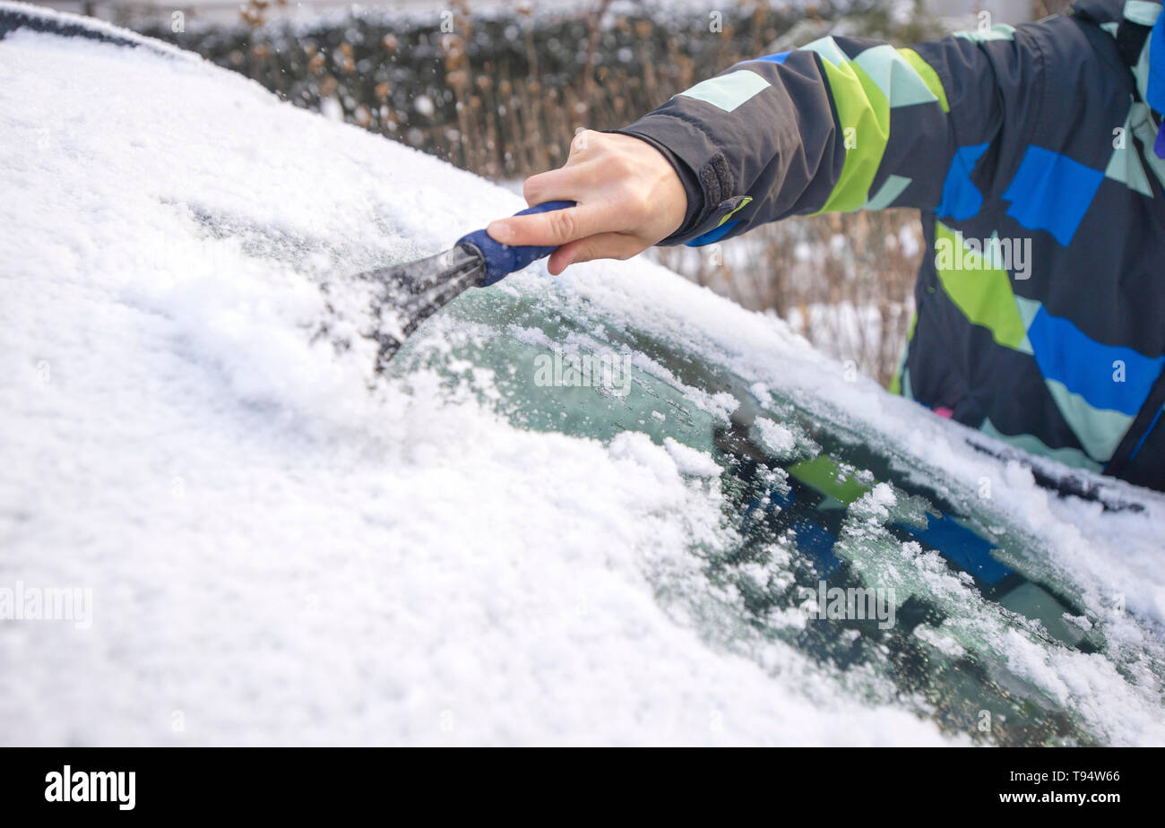 Scraping ice from the car window Stock Photo - Alamy