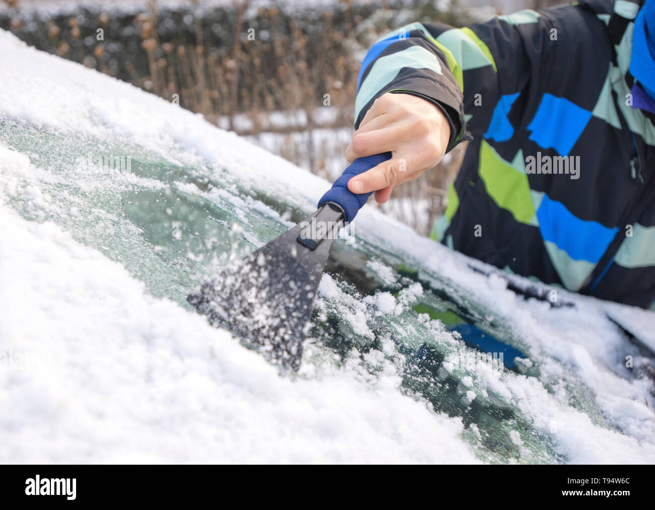 Scraping ice from the car window Stock Photo - Alamy