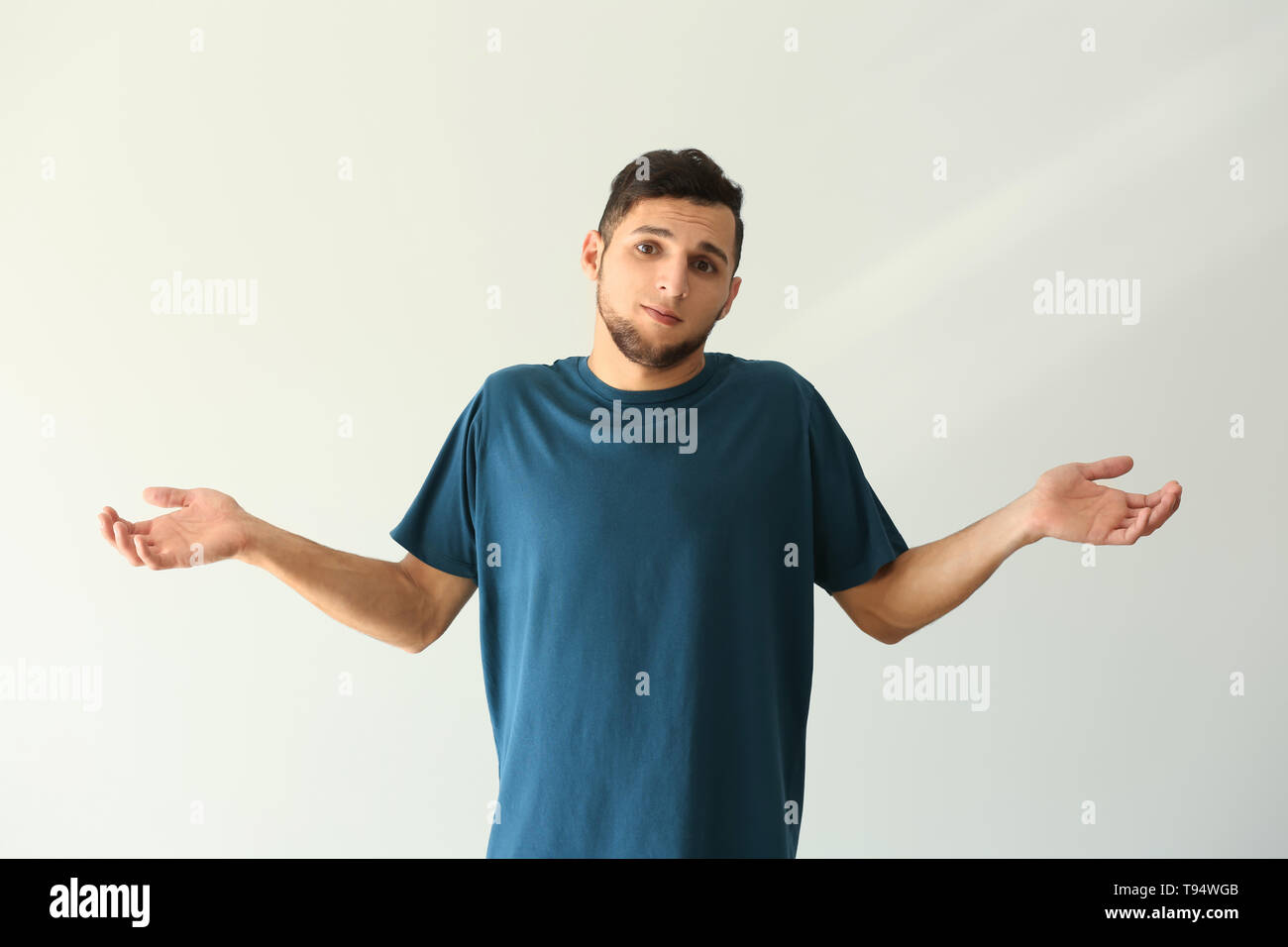 Emotional young man after making mistake on white background Stock ...
