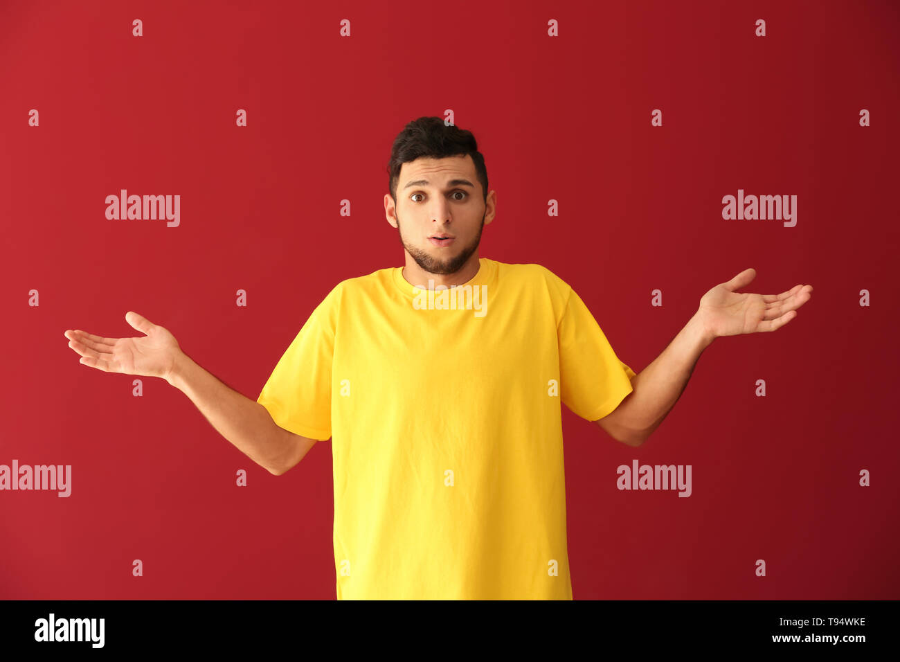 Emotional young man after making mistake on color background Stock ...