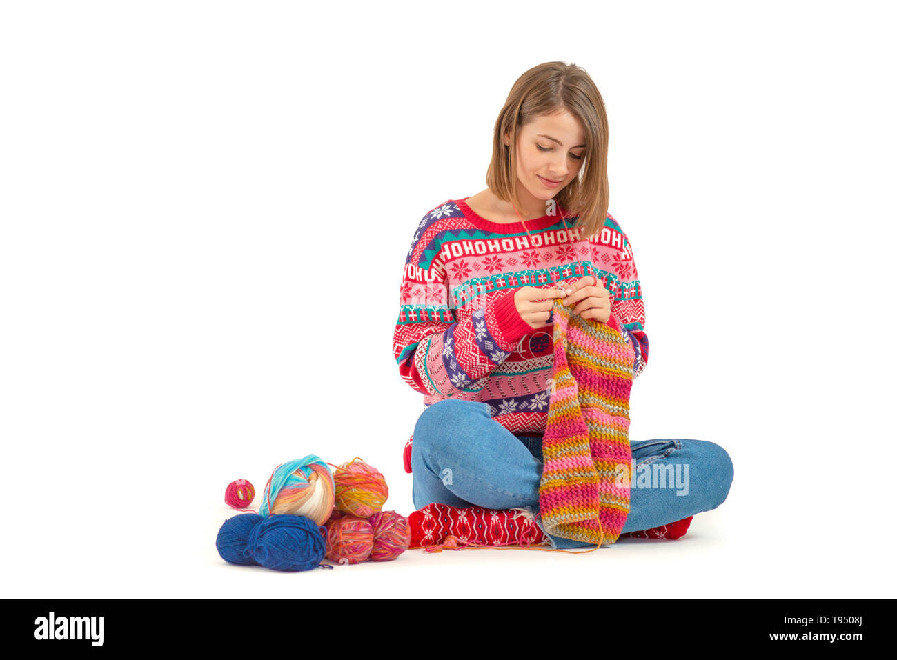 Young woman knitting isolated on white background Stock Photo - Alamy
