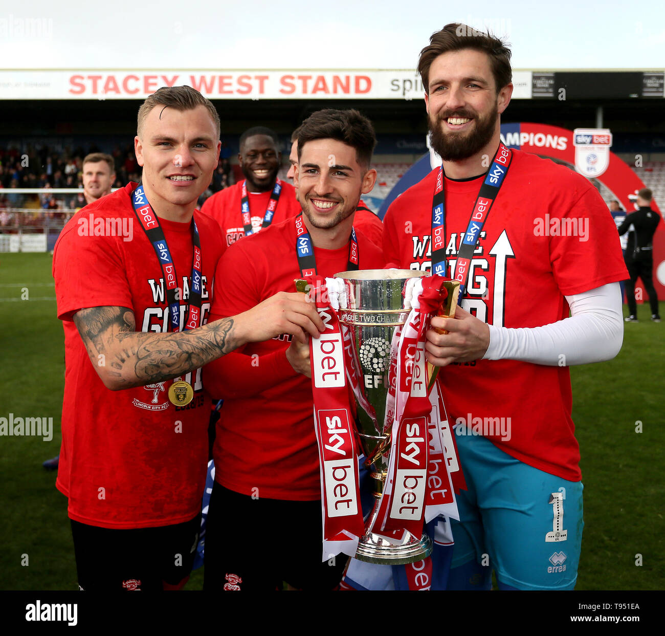 Lincoln City's Harry Anderson (left to right), Tom Pett (centre) and ...