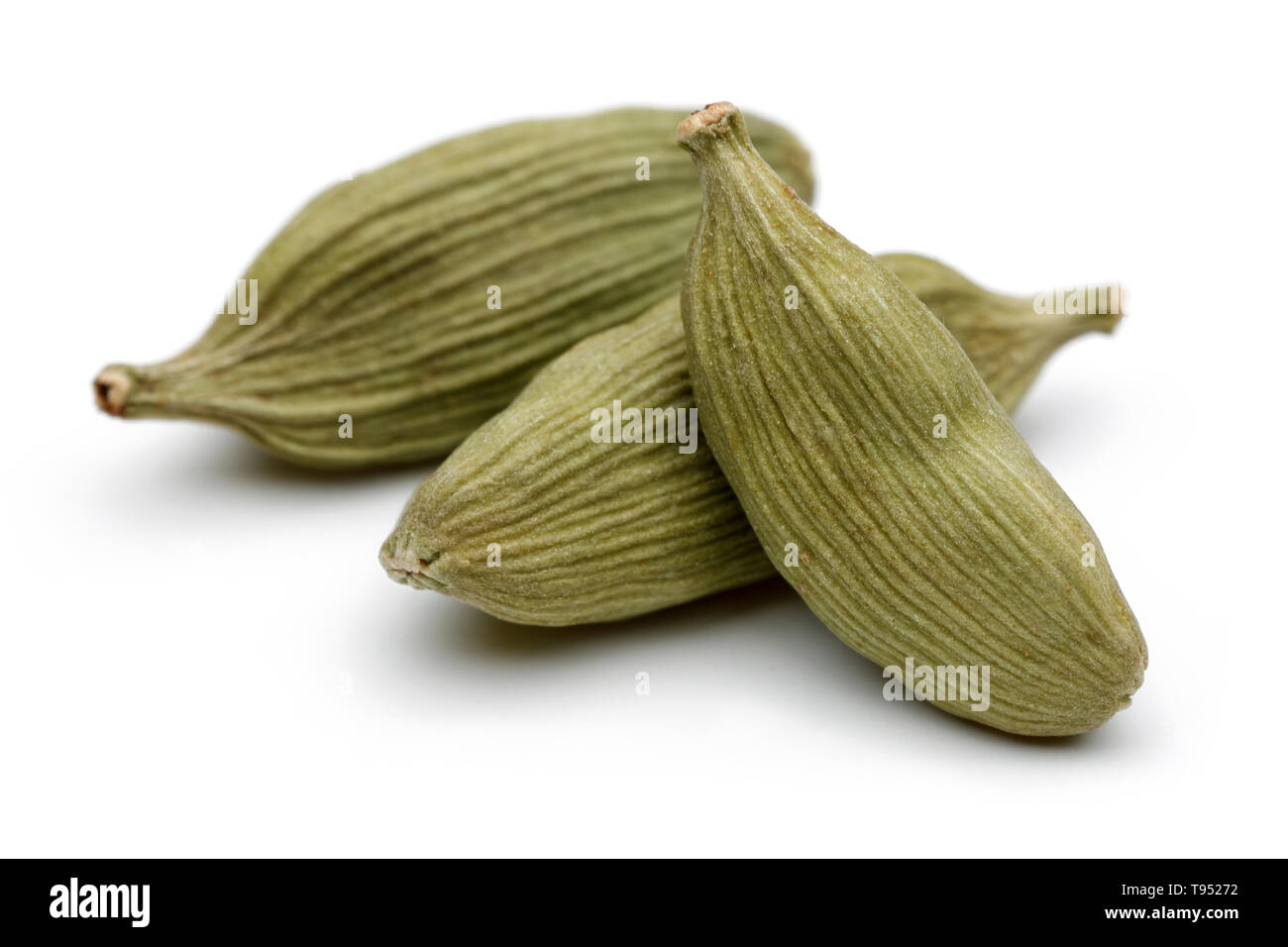 Cardamom pods isolated on white background Stock Photo - Alamy