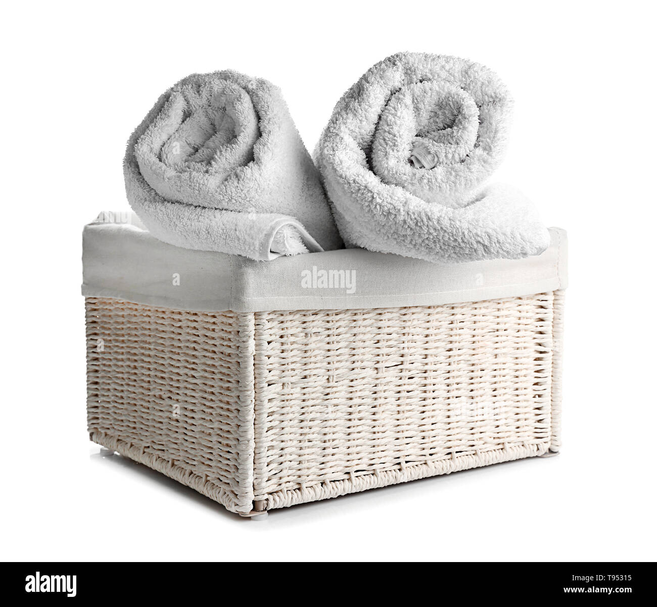 Towels in basket on white background Stock Photo - Alamy