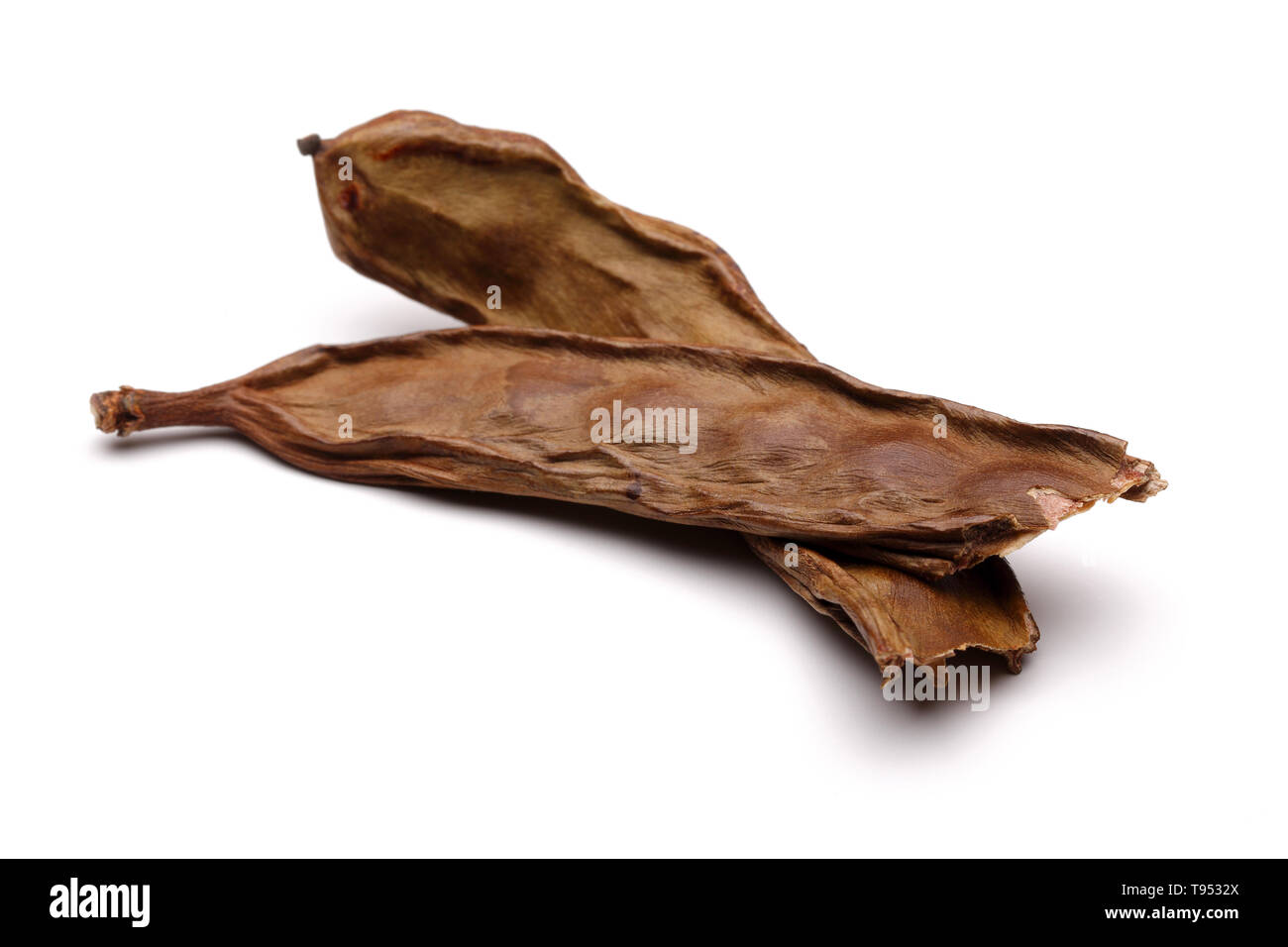 Ripe carob pods isolated on white background Stock Photo - Alamy