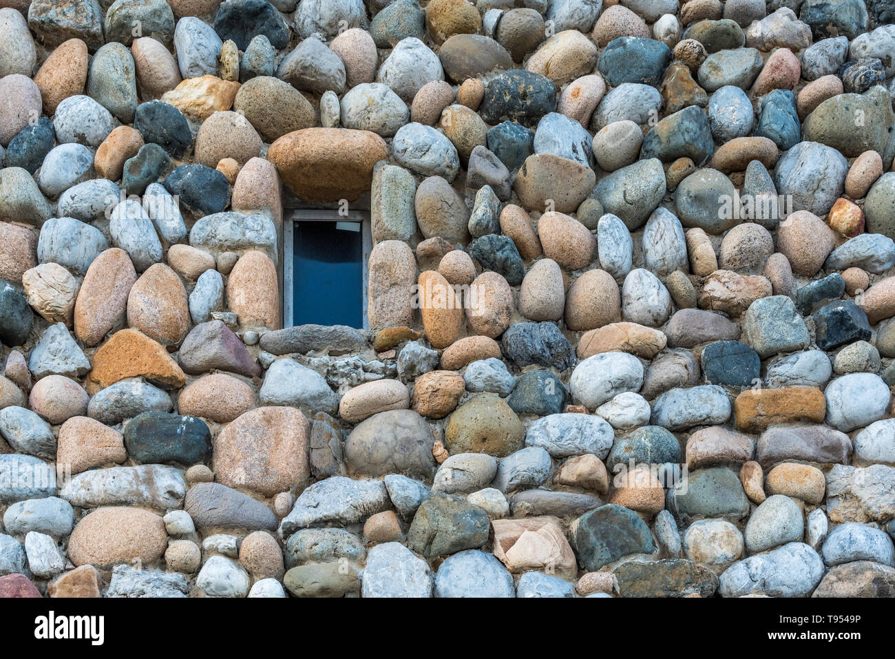 Different types of stones and pebbles of similar size arranged around ...