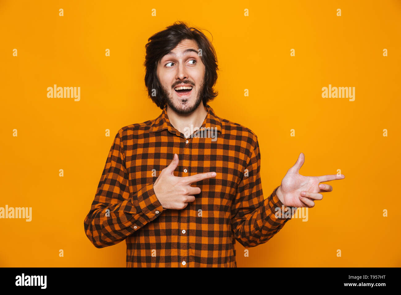 Image of a handsome young happy man isolated over yellow wall ...