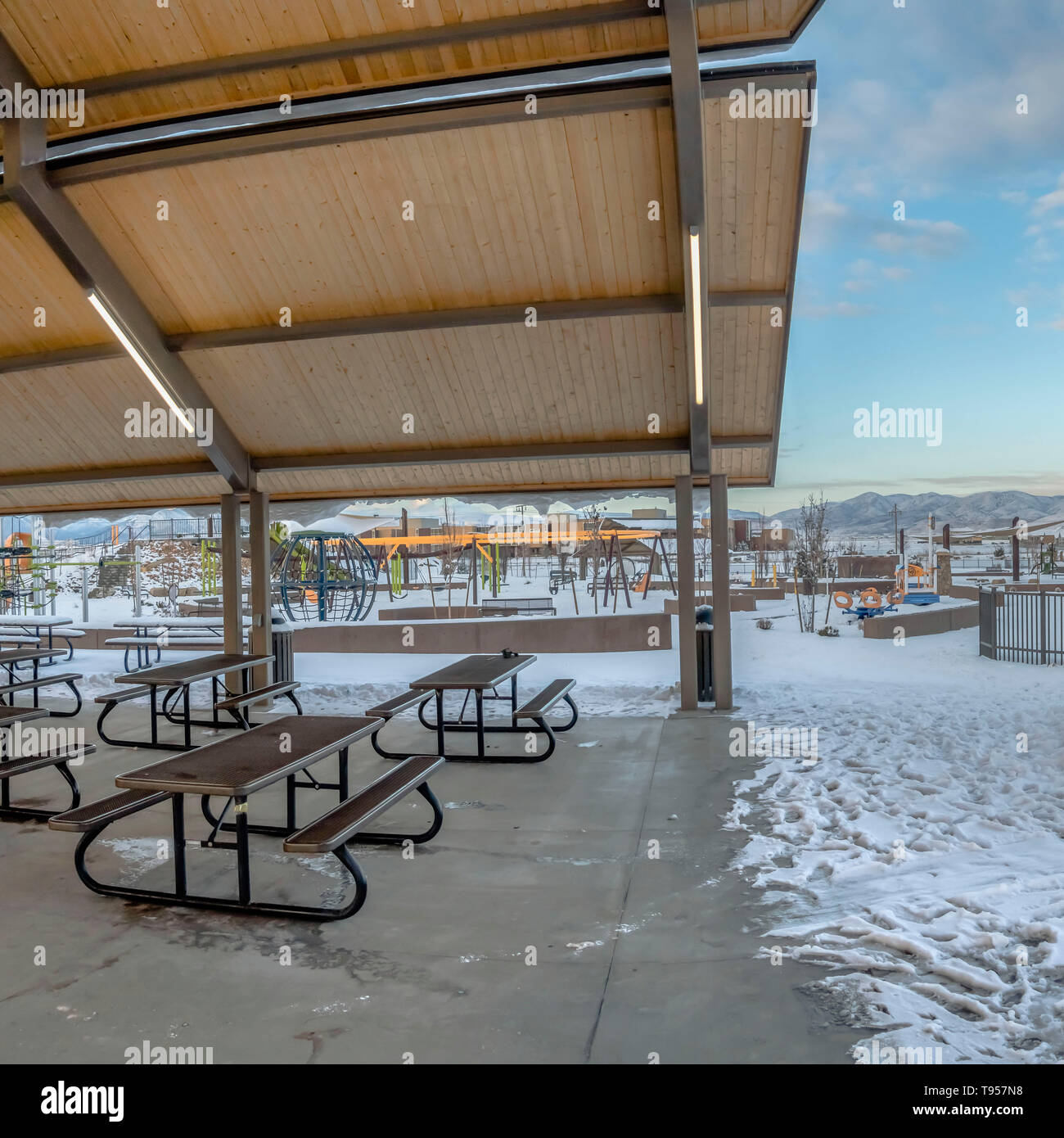Square Covered picnic area and playground at a park blanketed with snow ...