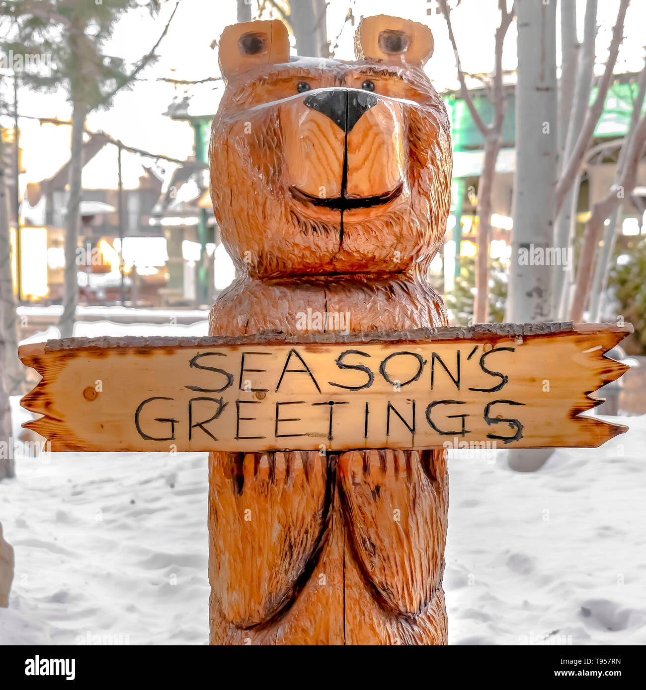 Square Bear wood sculpture on a landscape covered with powdery white ...