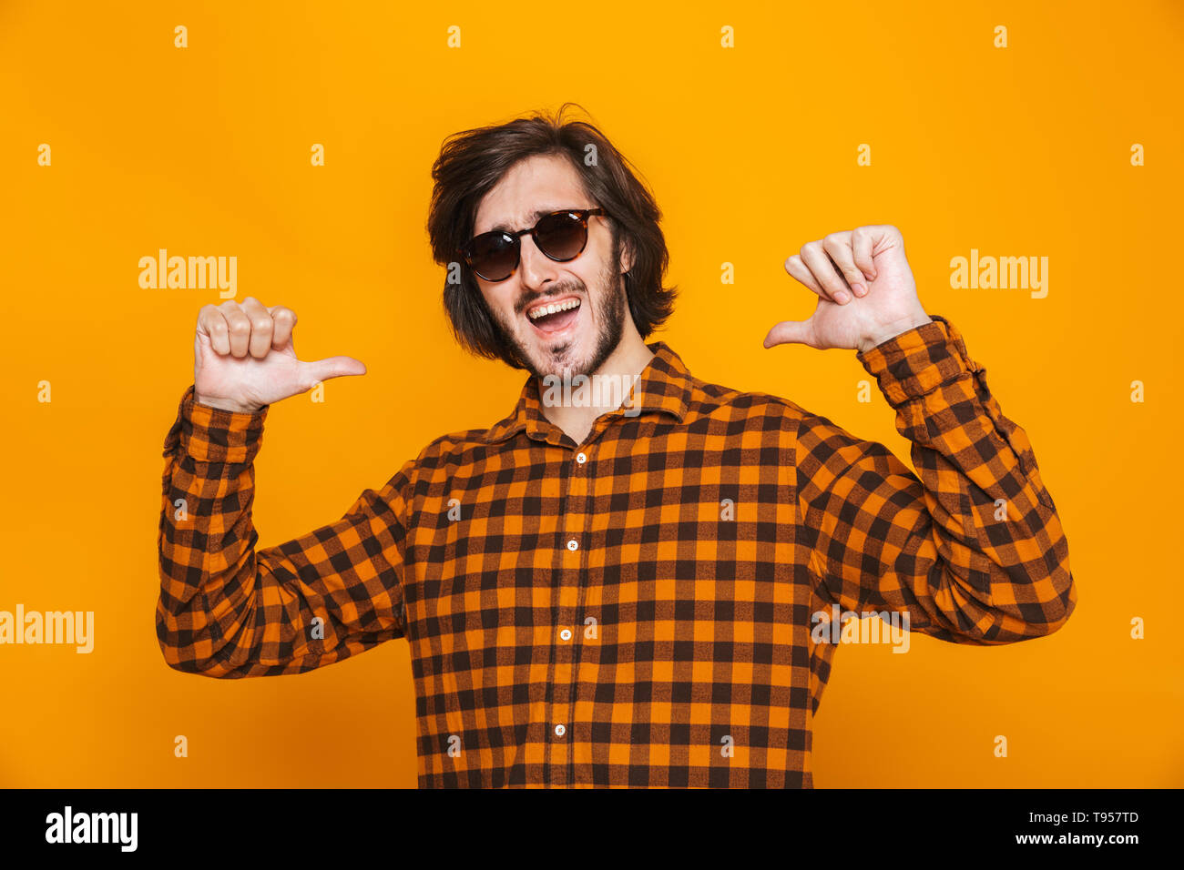 Portrait of fashionable guy 20s wearing plaid shirt and sunglasses ...
