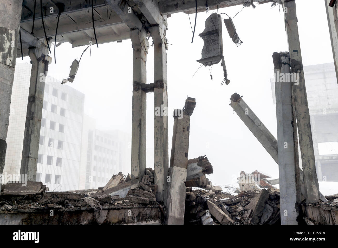The destroyed big concrete building in a foggy haze. The remains of the ...