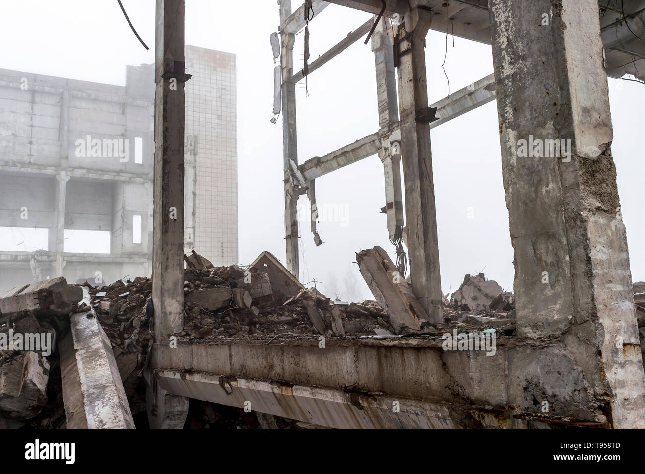 The destroyed big concrete building in a foggy haze. The remains of the ...