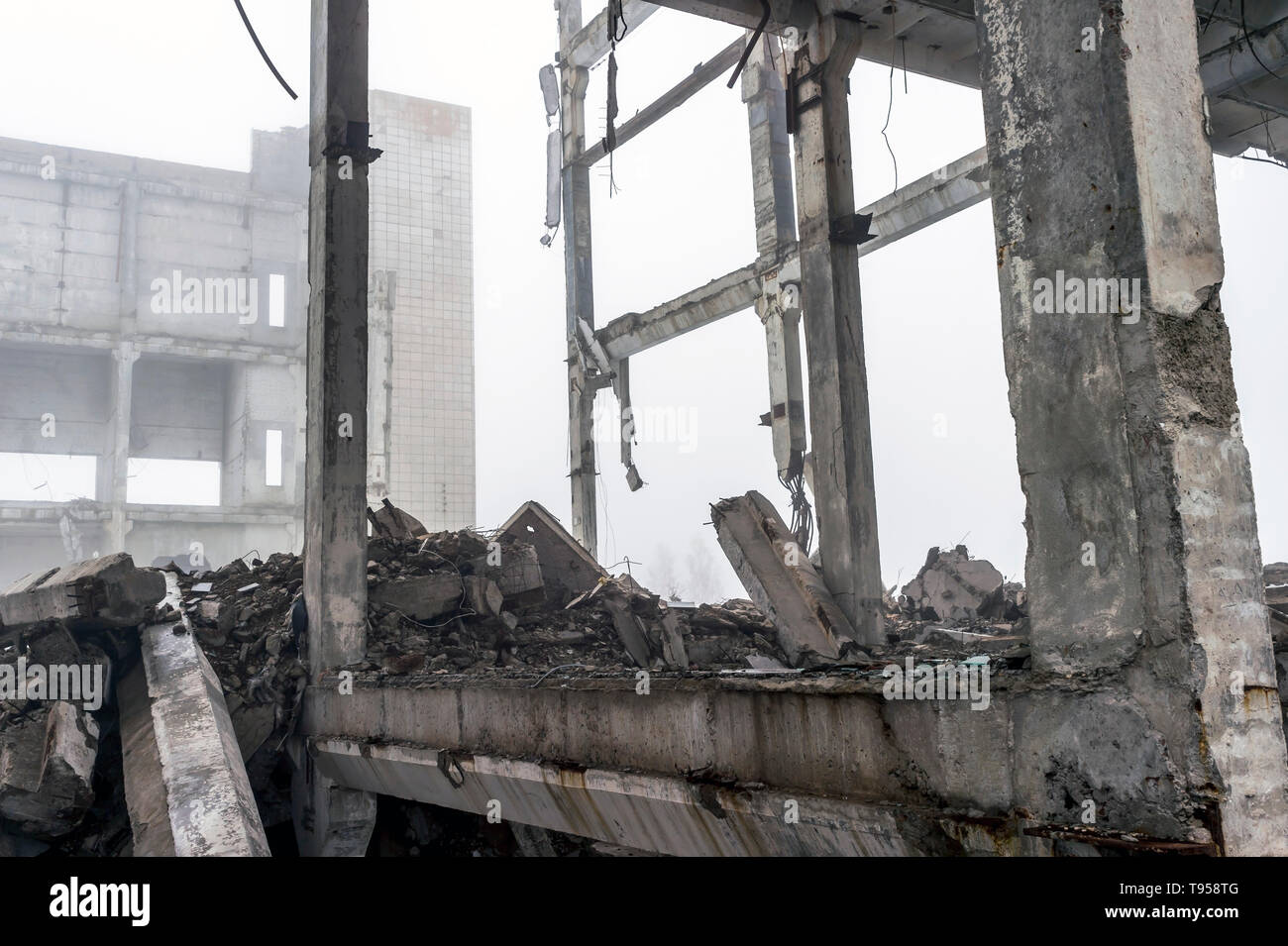 The destroyed big concrete building in a foggy haze. The remains of the ...