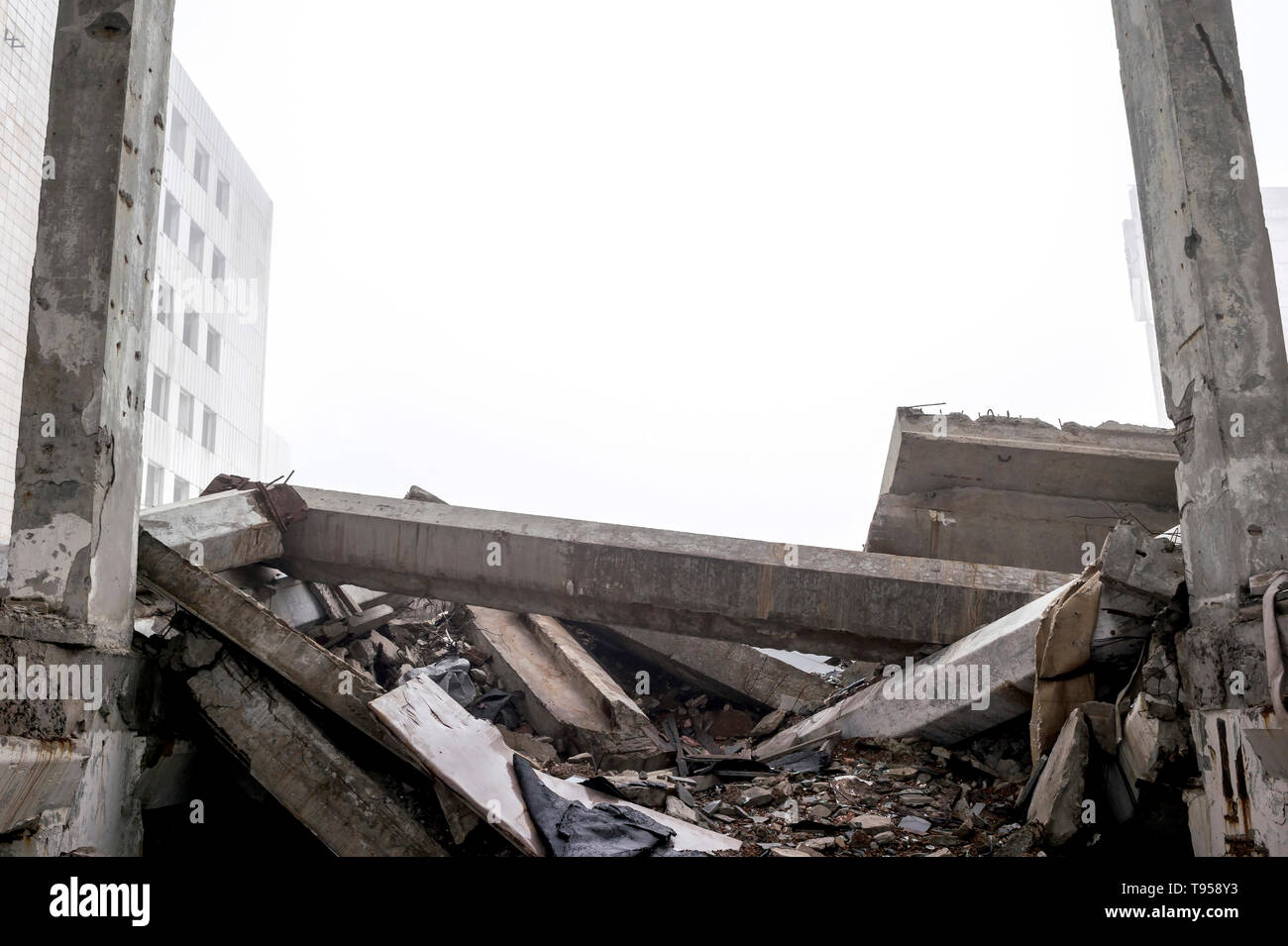 The destroyed big concrete building in a foggy haze. The remains of the ...