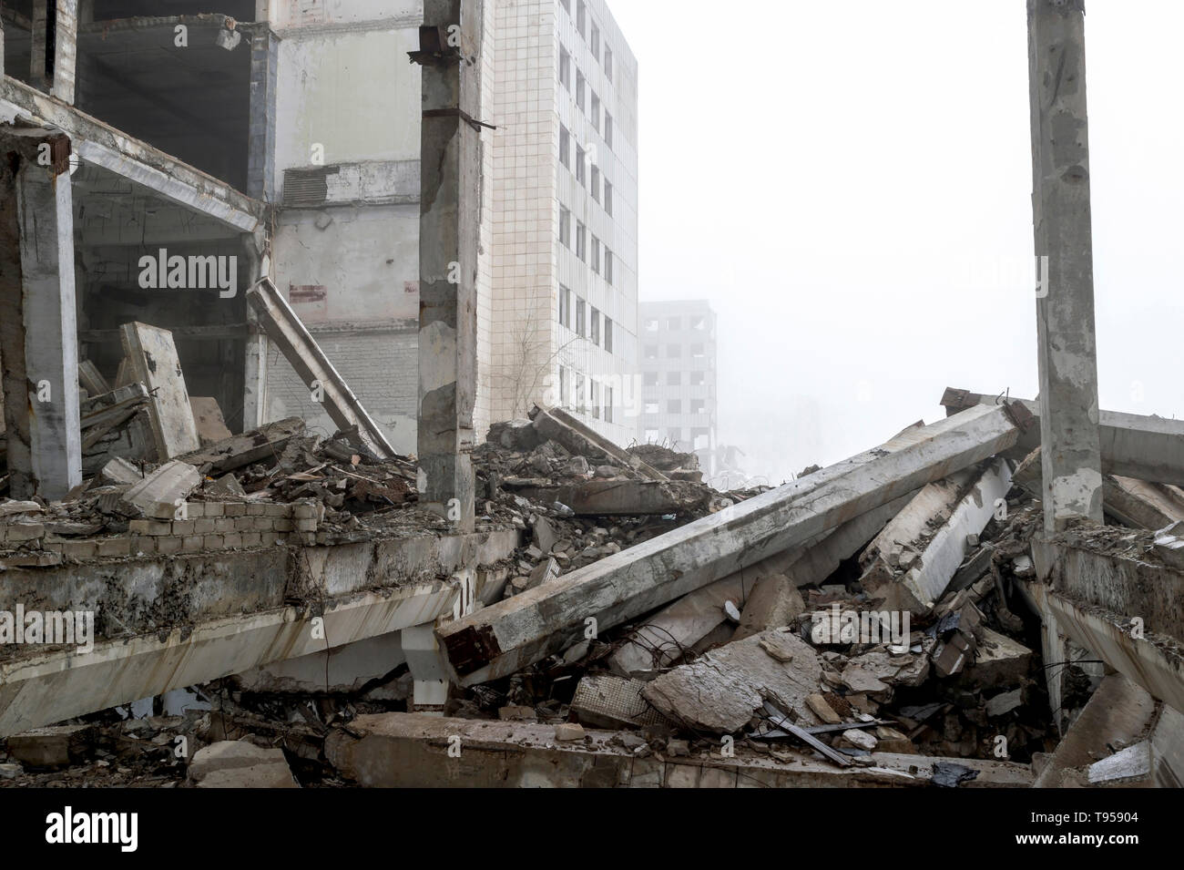 The destroyed big concrete building in a foggy haze. The remains of the ...