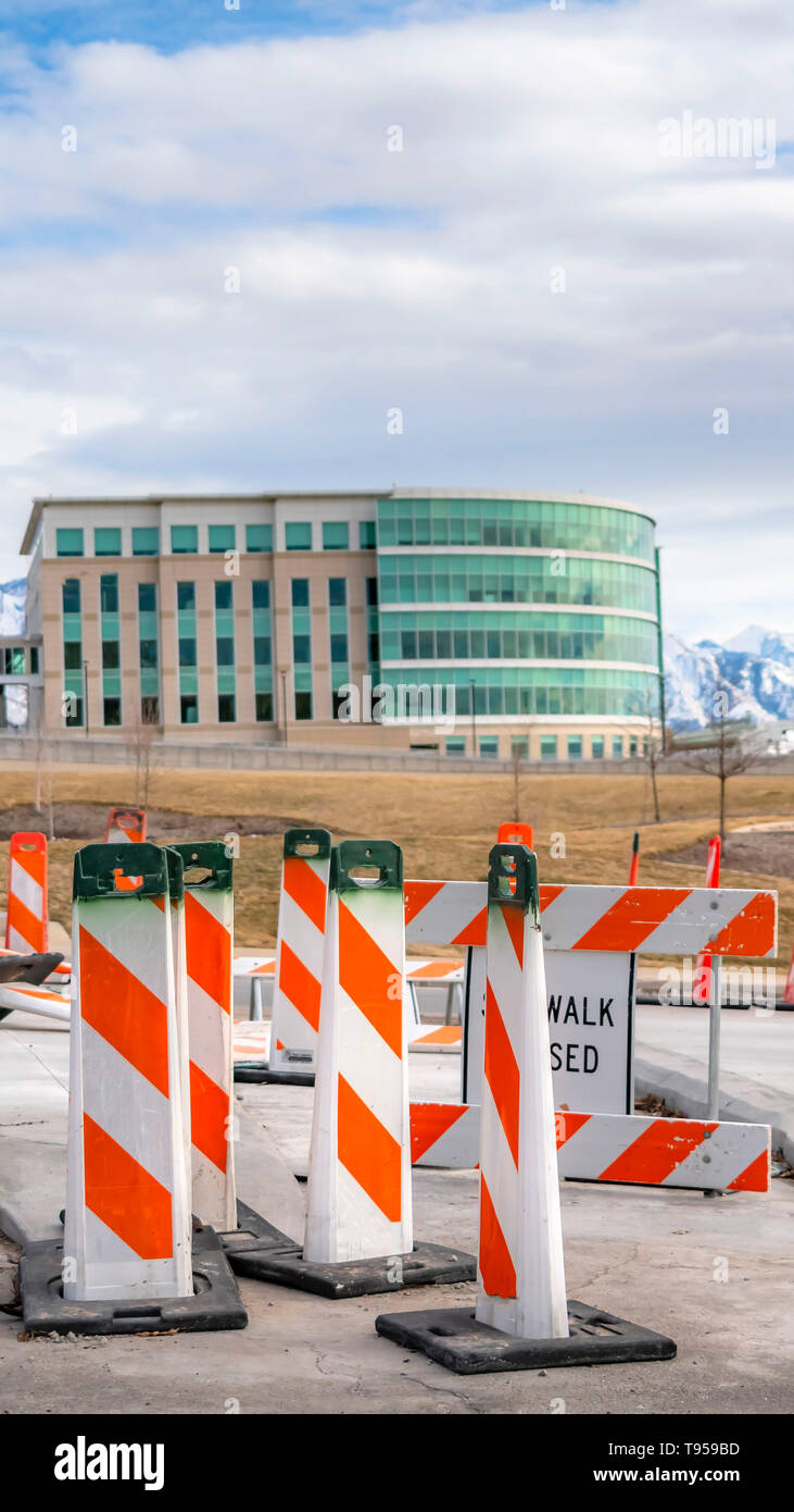 Clear Vertical Sidewalk Closed sign and road safety poles on a paved ...