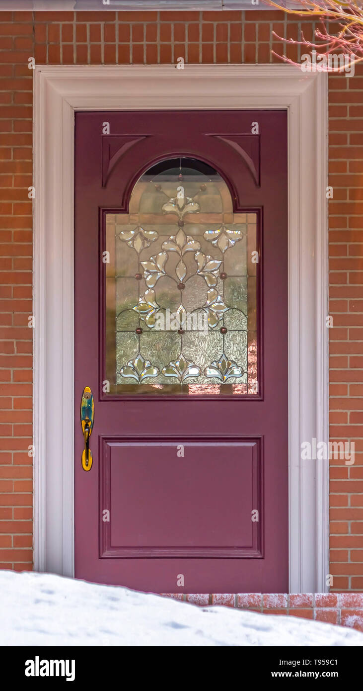Clear Vertical Entrance of a home with a beautiful front door and snowy ...