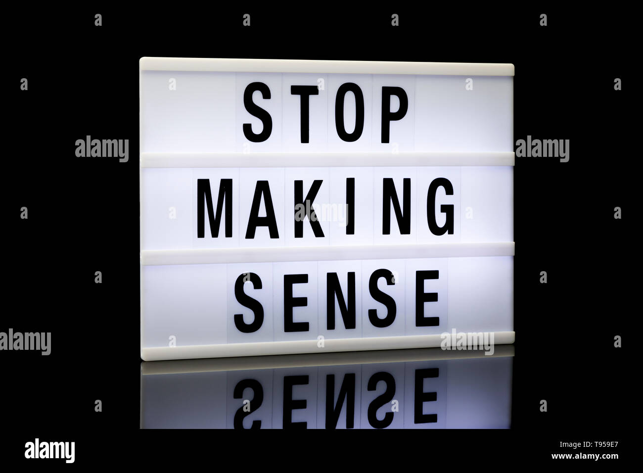 stop making sense, phrase written on lightbox reflected on black ...