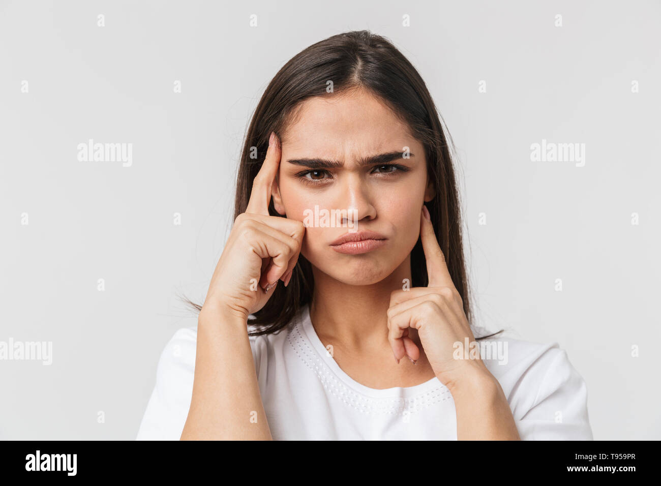 Close up portrait of a confused pretty young woman casualy dressed ...