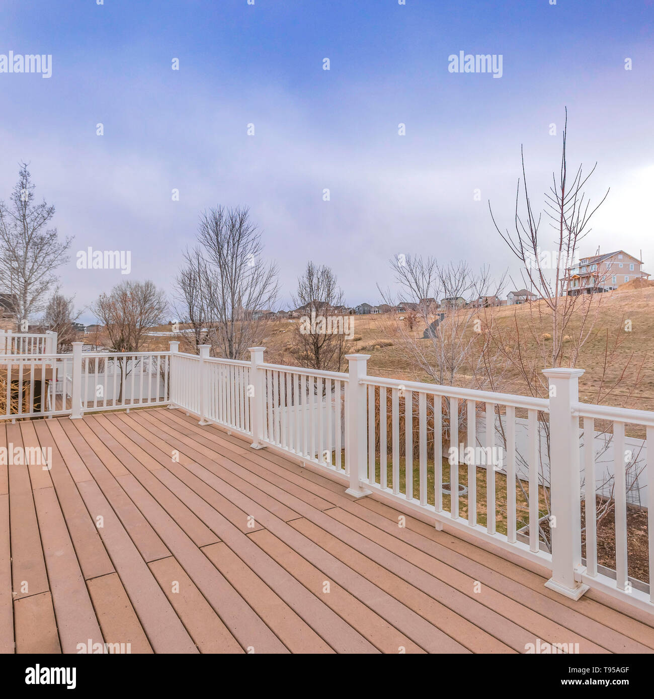 Clear Square Spacious balcony of a home with wooden floor and white ...