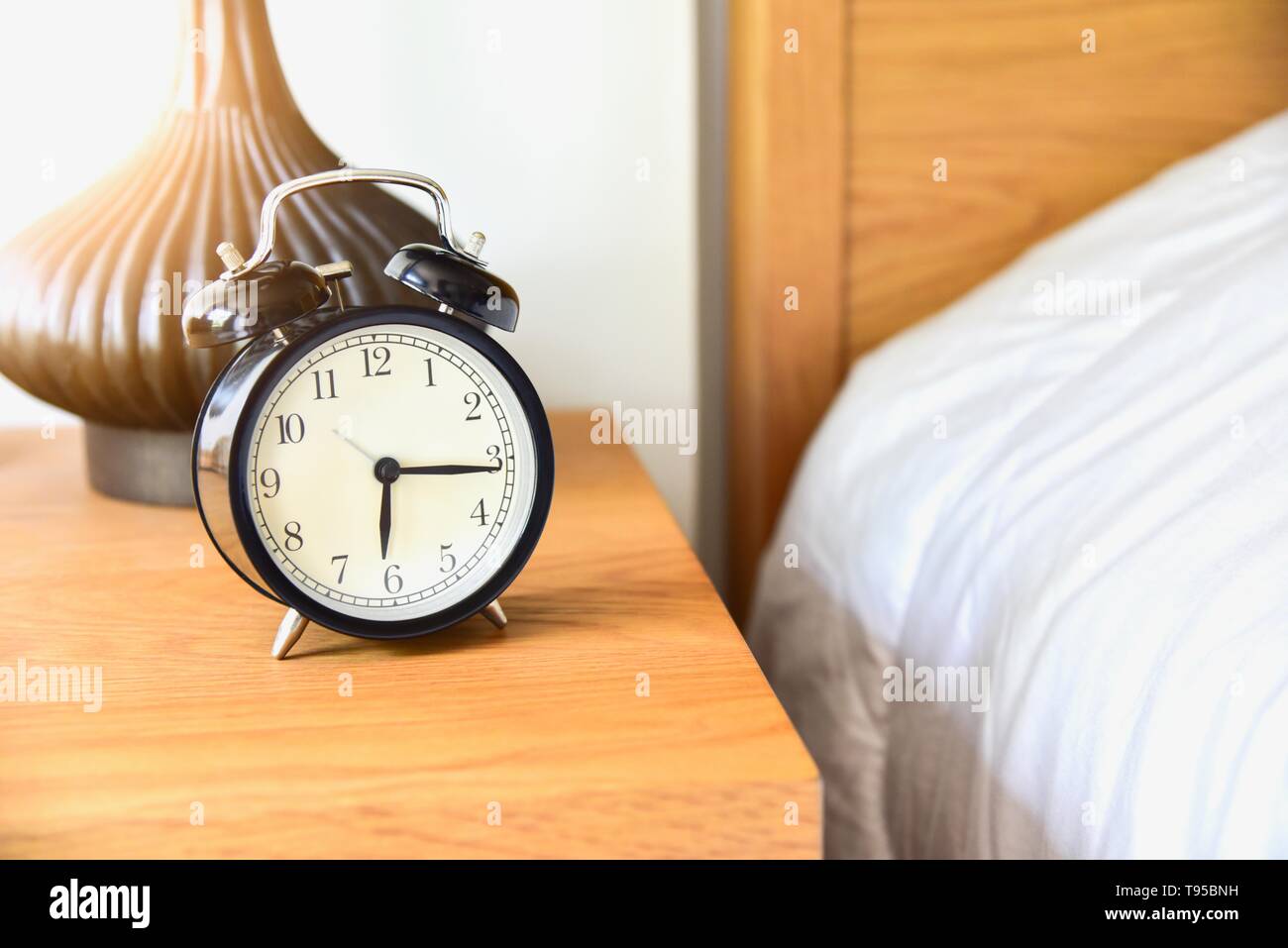 Vintage Morning Alarm Clock Isolated on Table Stock Photo - Alamy