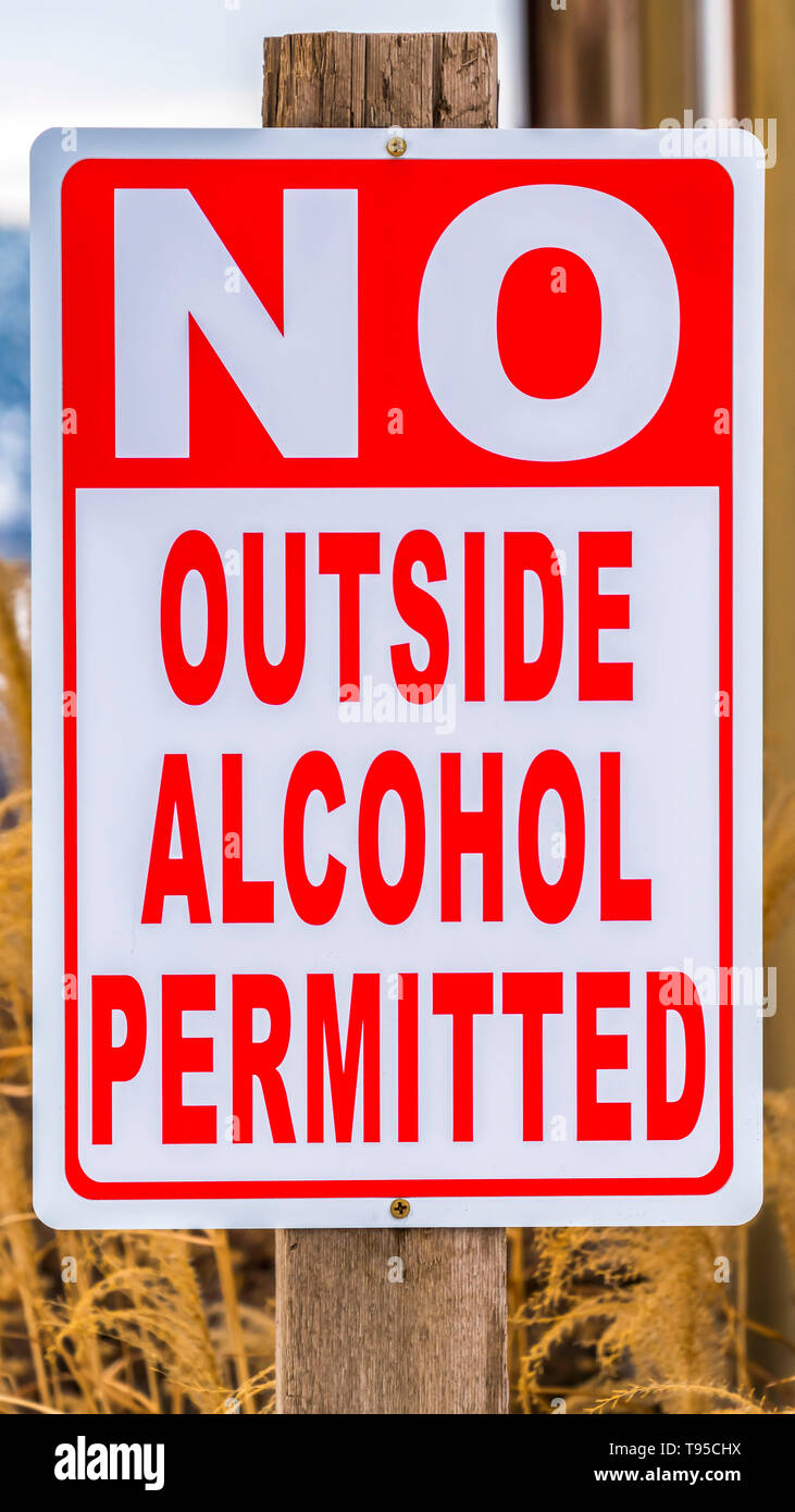 Vertical Close up view of a sign post that reads No Outside Alcohol ...