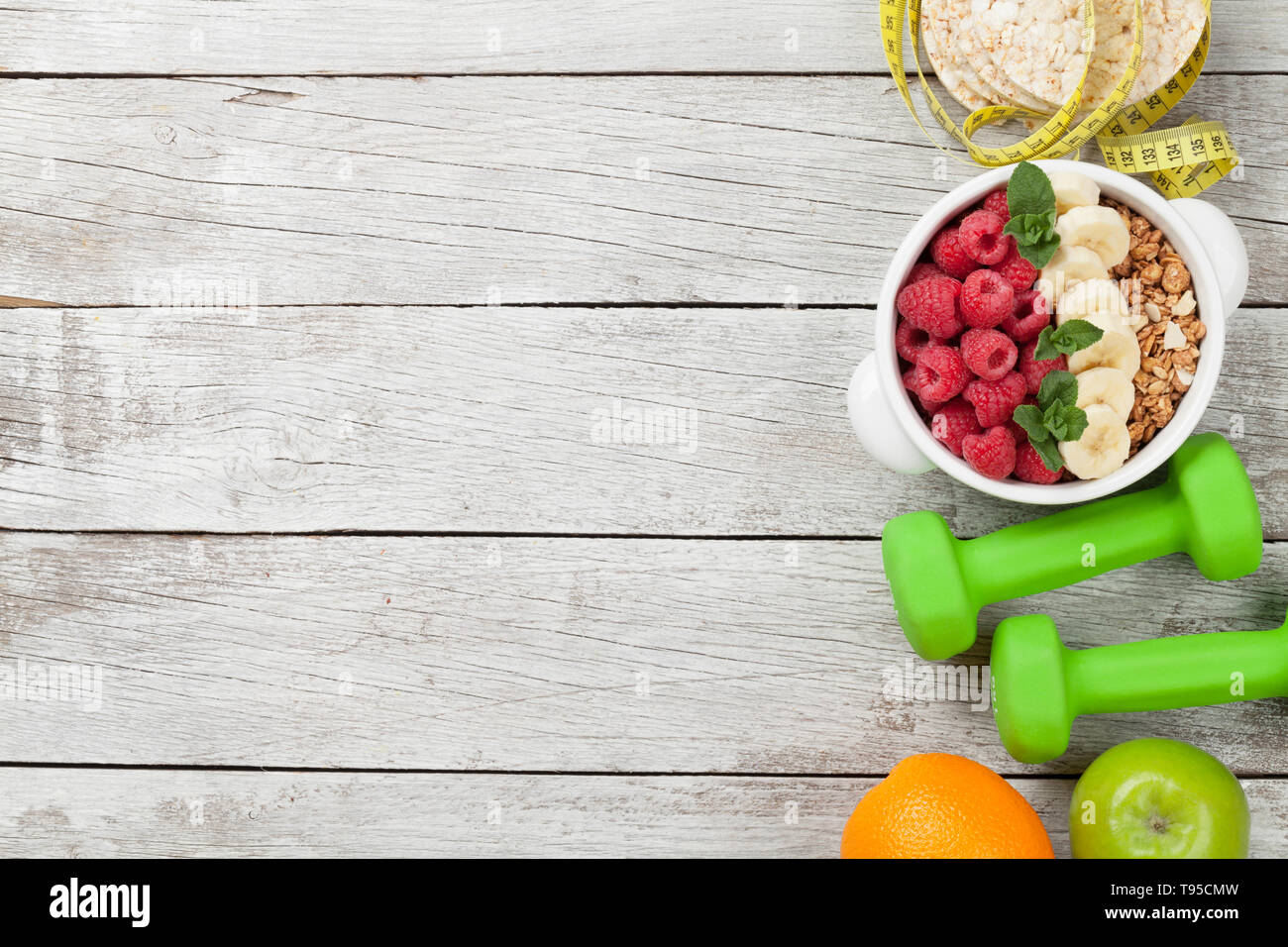 Healthy food and fitness concept. Breakfast cereal, fruits, nuts and ...