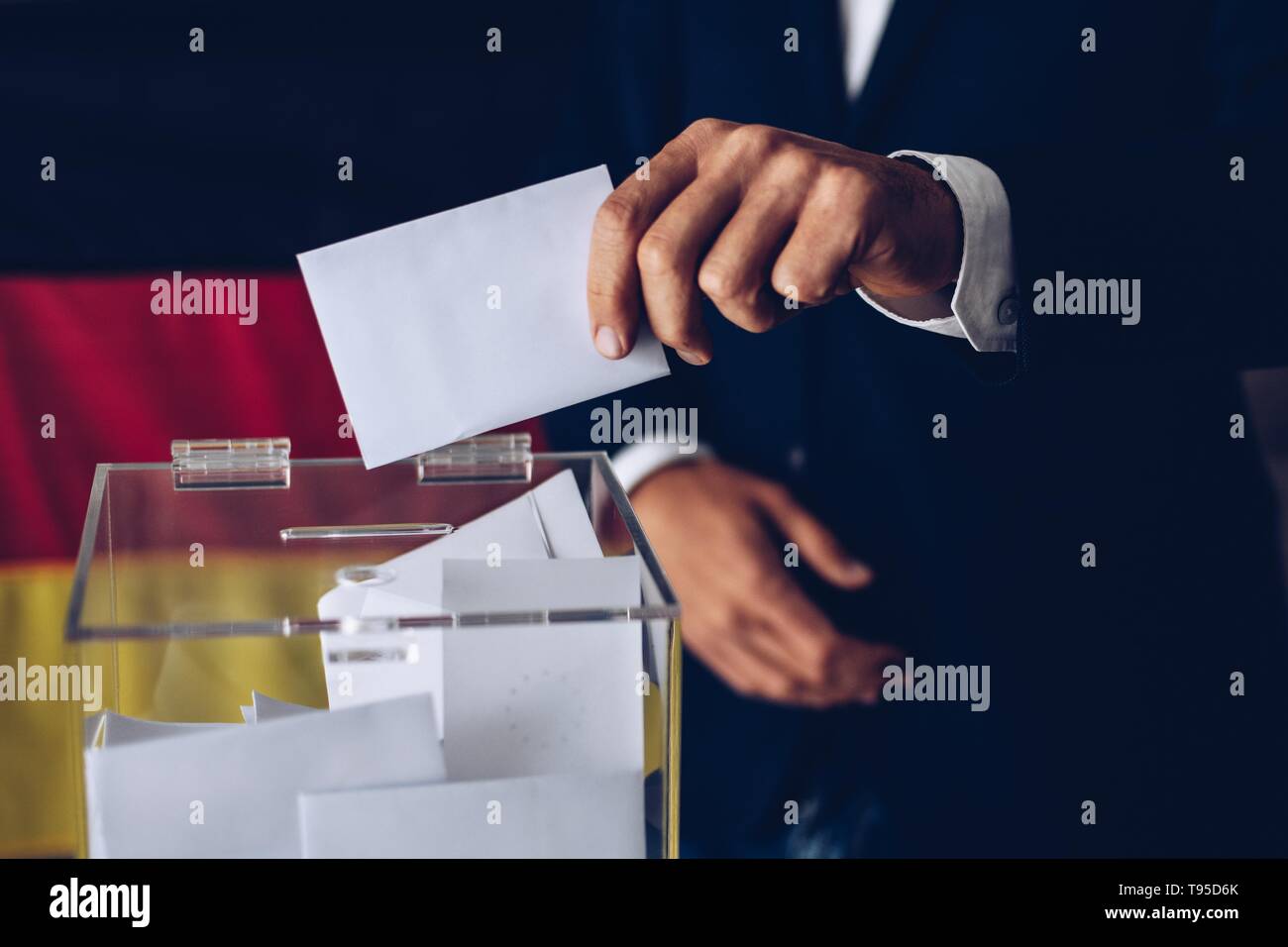 Elections in Germany. Man throwing his vote into the ballot box. German ...