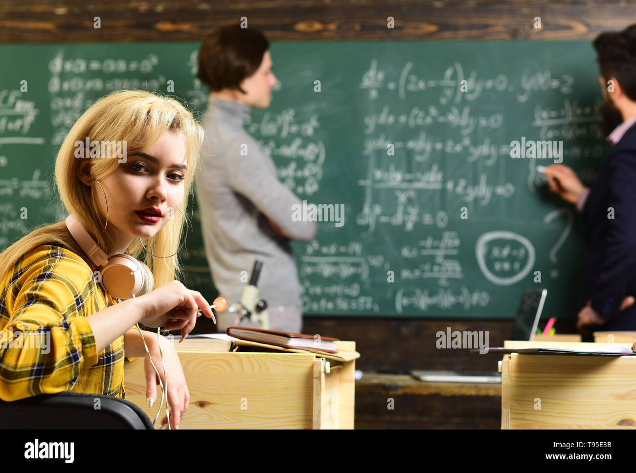 High school college students studying and reading together in class ...