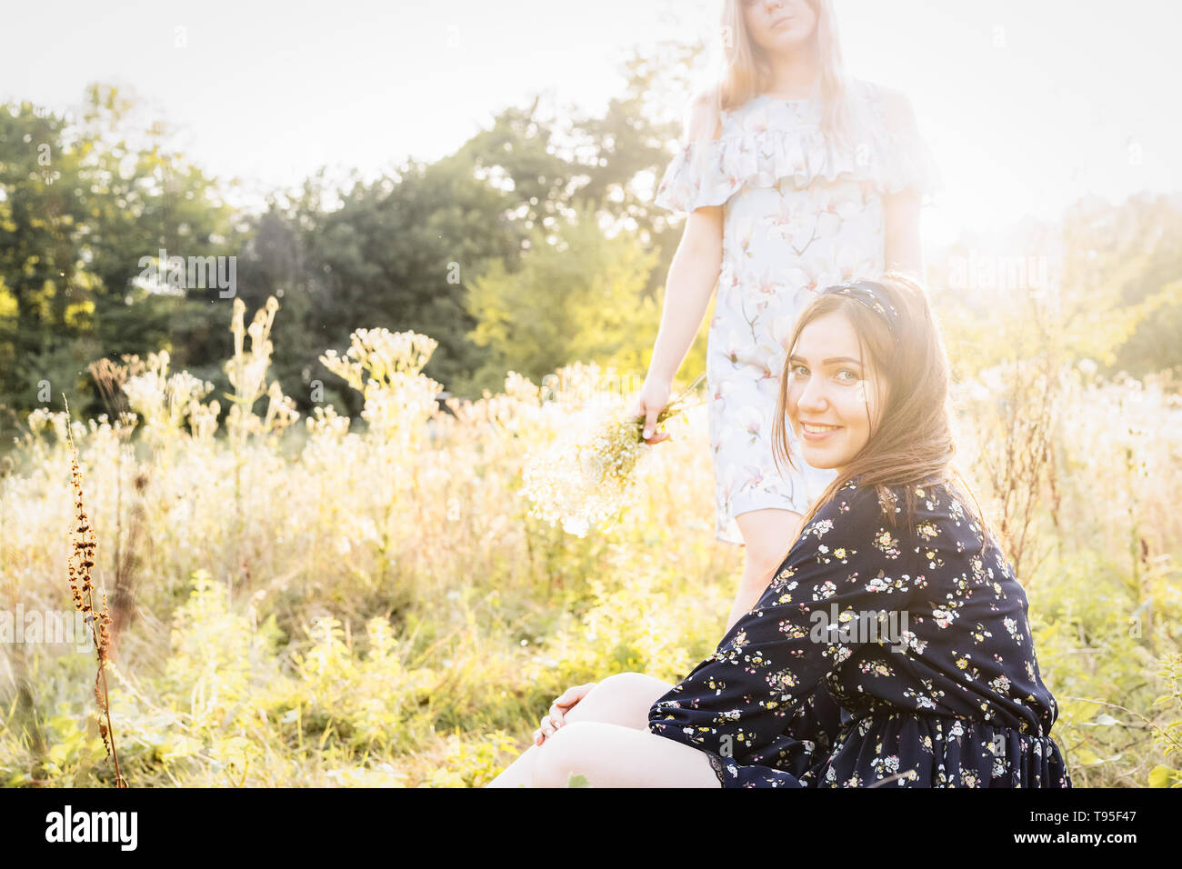 Two girls in white dresses hi-res stock photography and images - Alamy