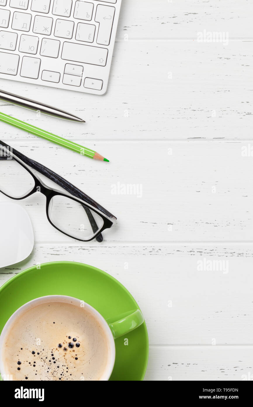 Office workplace table with coffee cup, supplies and computer. Flat lay ...