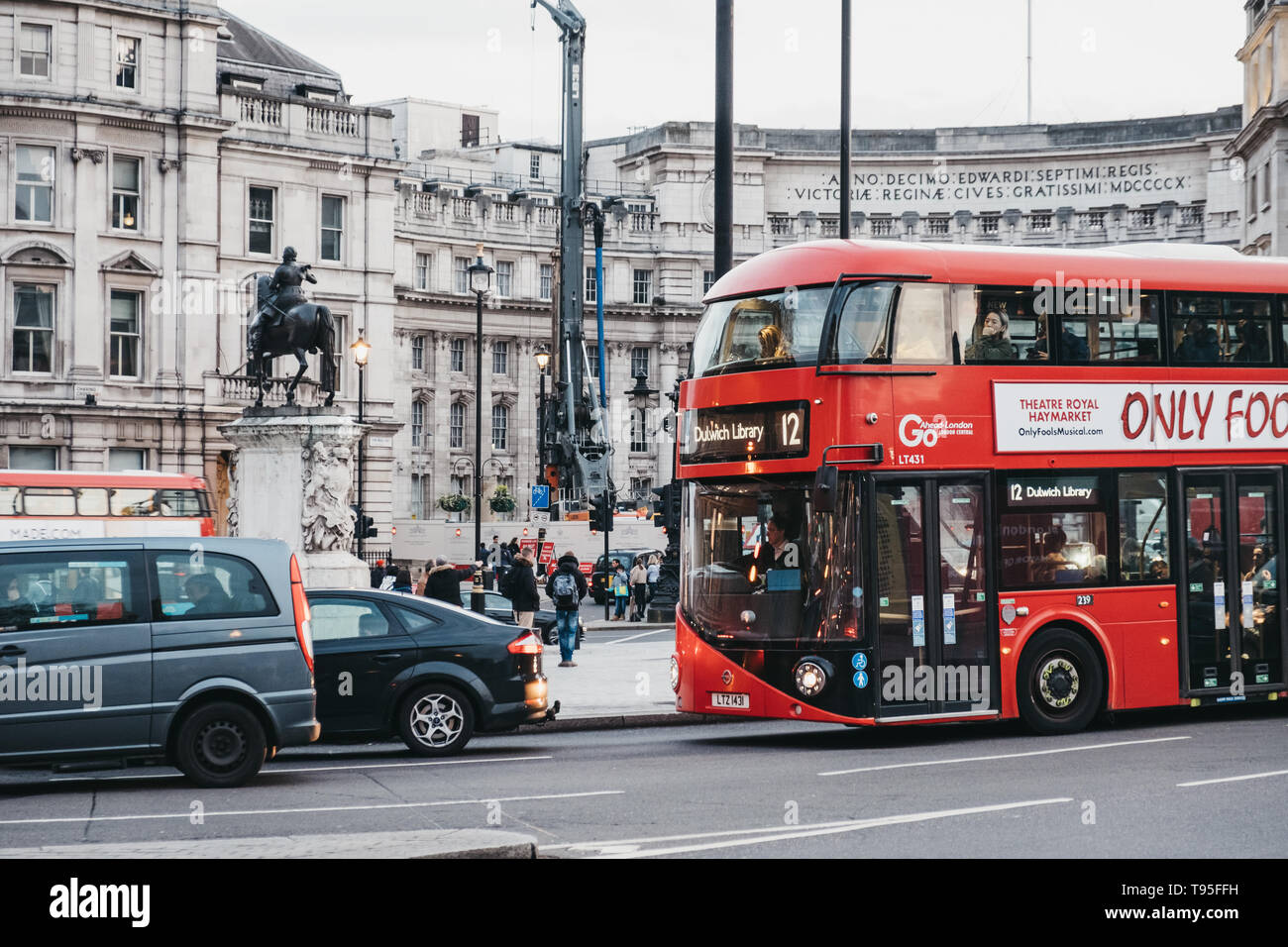 London, UK - April 14, 2019: Cars and a red double decker bus in ...
