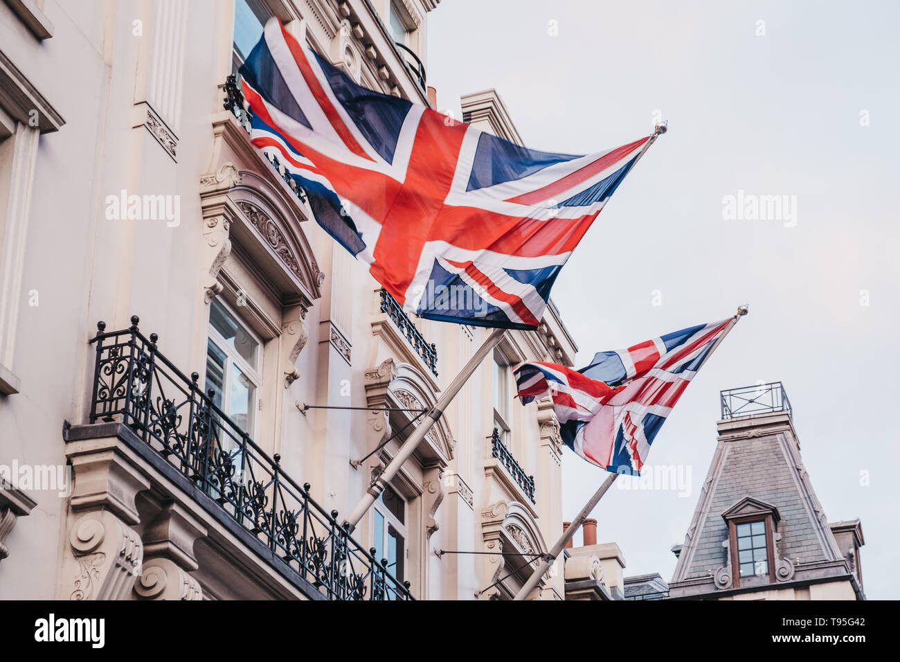 Close up of a Union Jack British flag flowing in the wind, on a pole ...