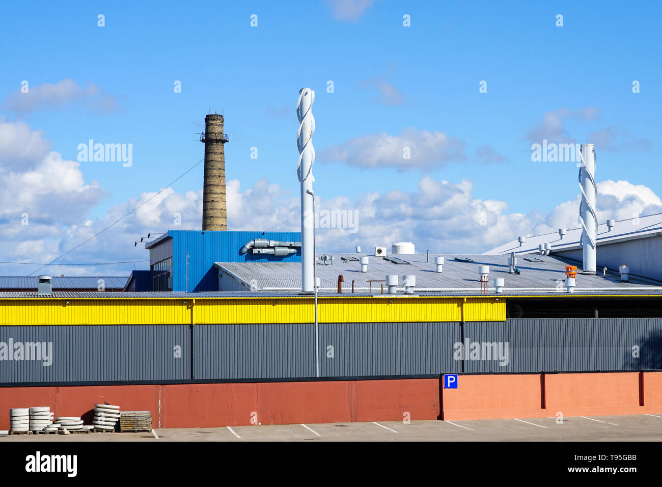 colorful wall of modern factory building and roof with exhaust and ...