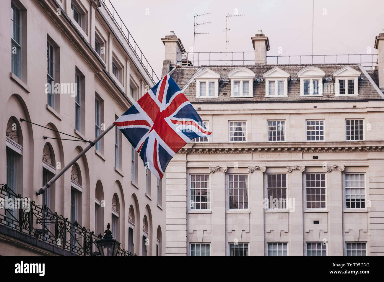 Close up of a Union Jack British flag flowing in the wind, on a pole ...