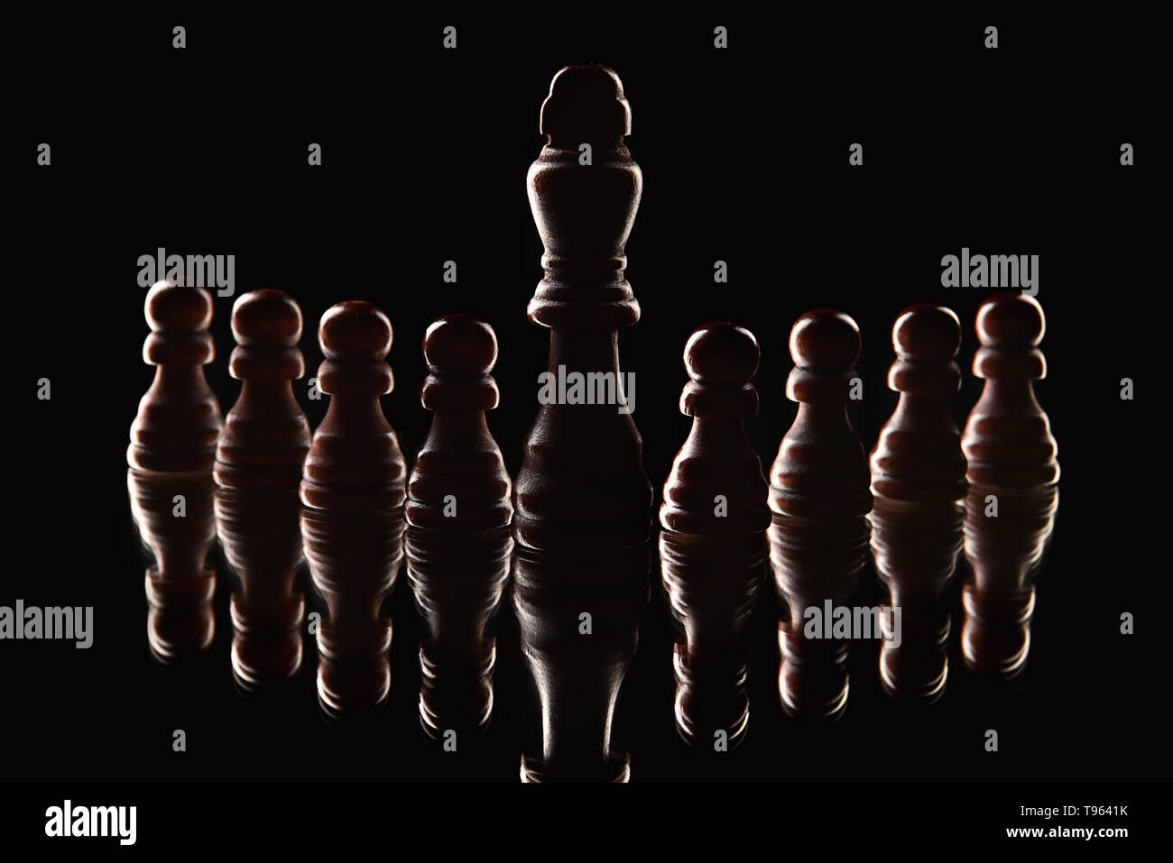 Chess pieces with reflection on dark background Stock Photo - Alamy