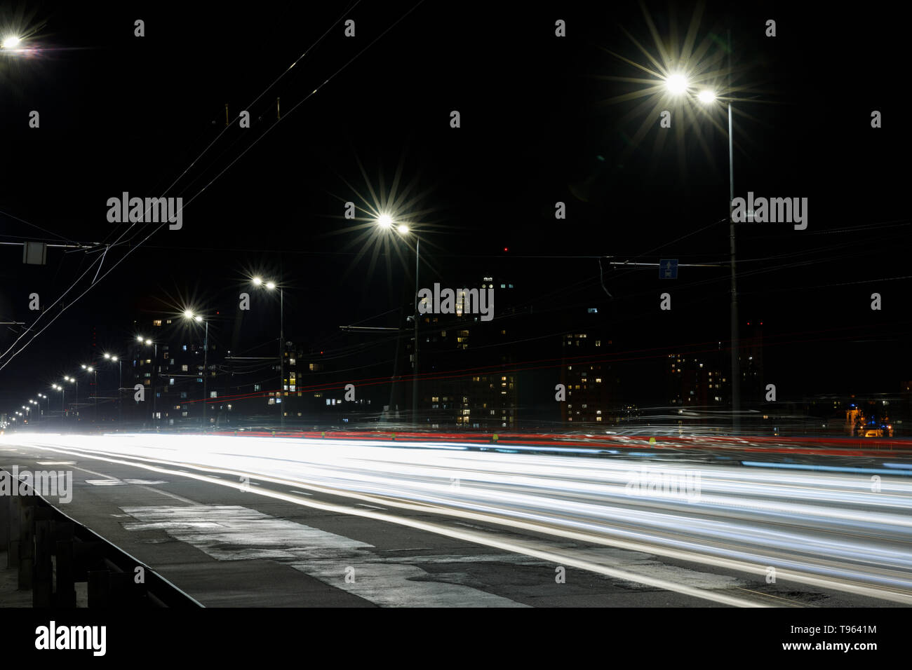 long exposure of lights on road at nighttime near buildings Stock Photo ...