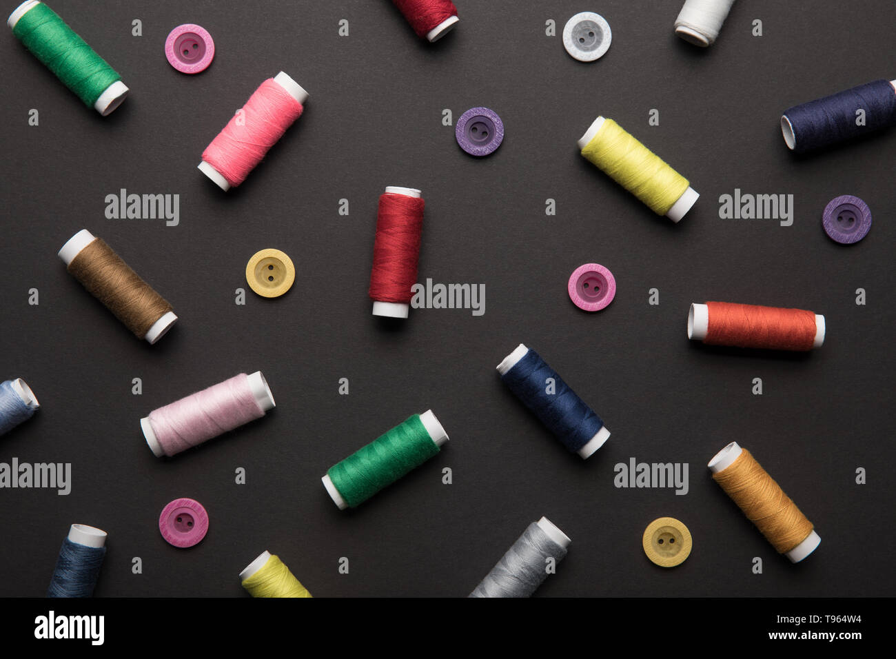 top view of colorful thread coils with various buttons isolated on ...